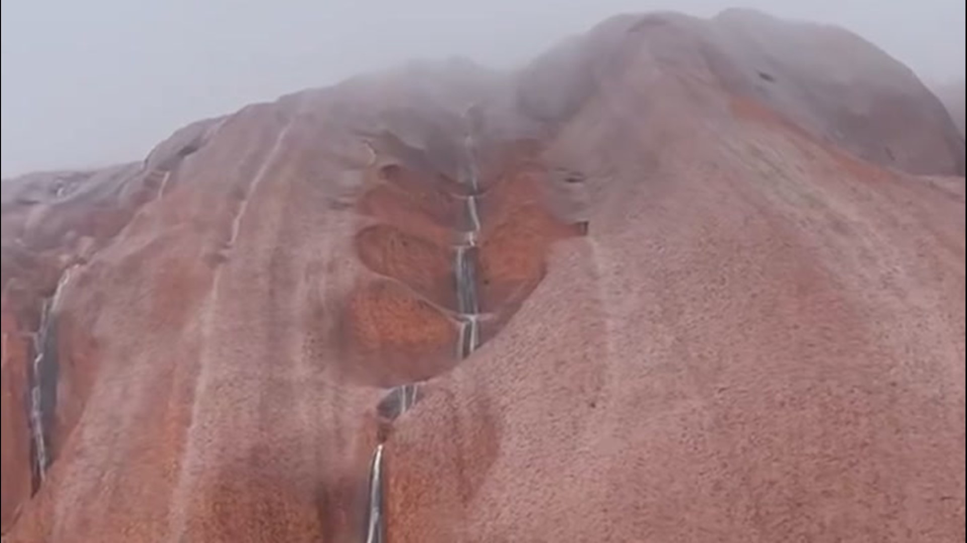 Rare rain cascades down Australia's iconic Uluru monolith | wthr.com