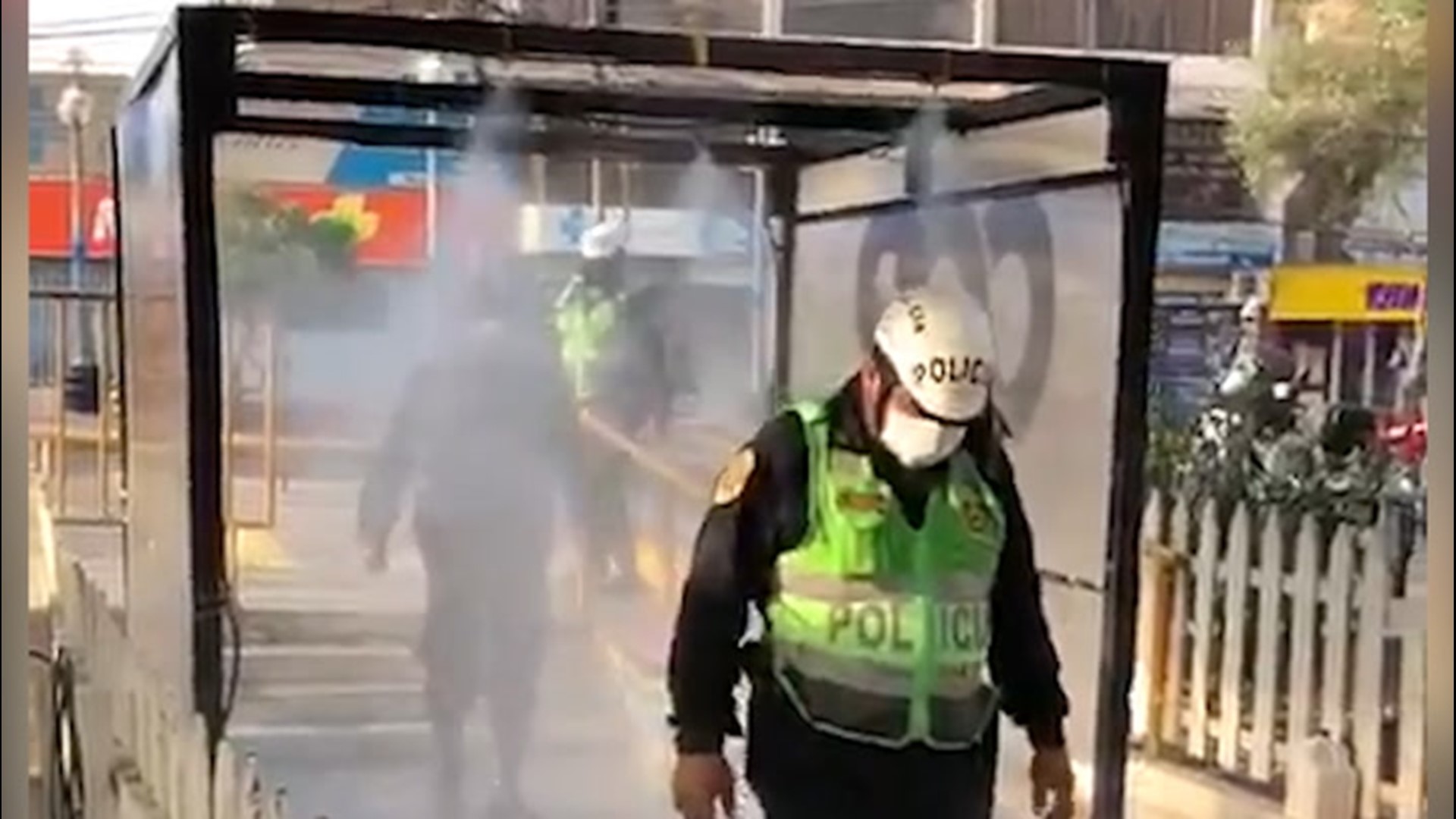 Police officers walk through decontamination booth | fox61.com
