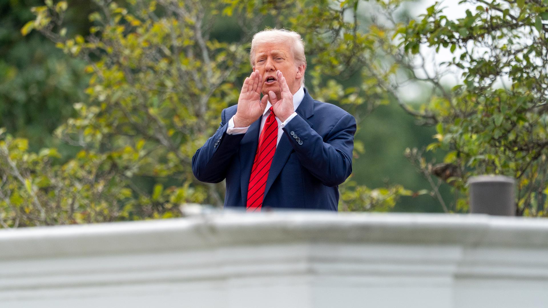 Trump appears on White House roof, shouts answers to reporter questions ...