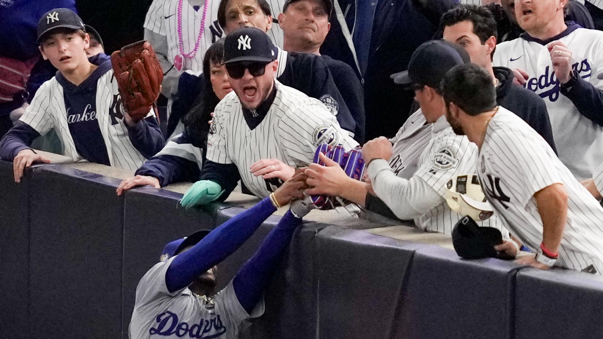 Fans try to rip ball from Dodgers player's glove, get ejected | fox61.com