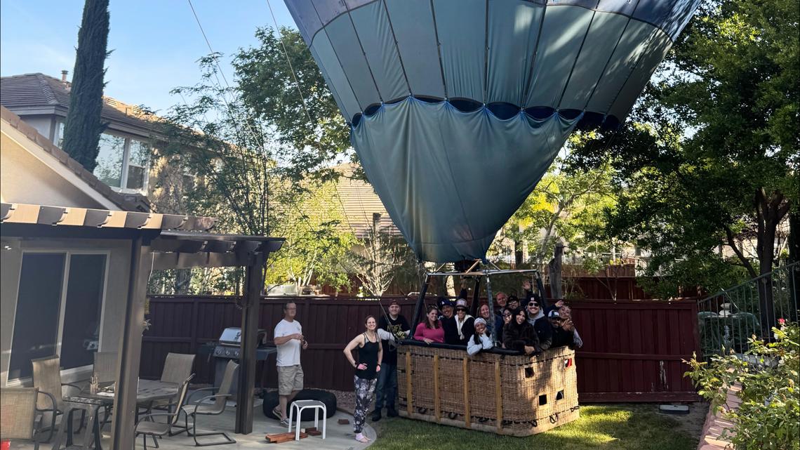 Mind if we drop in? Hot air balloon with 13 aboard makes emergency ...