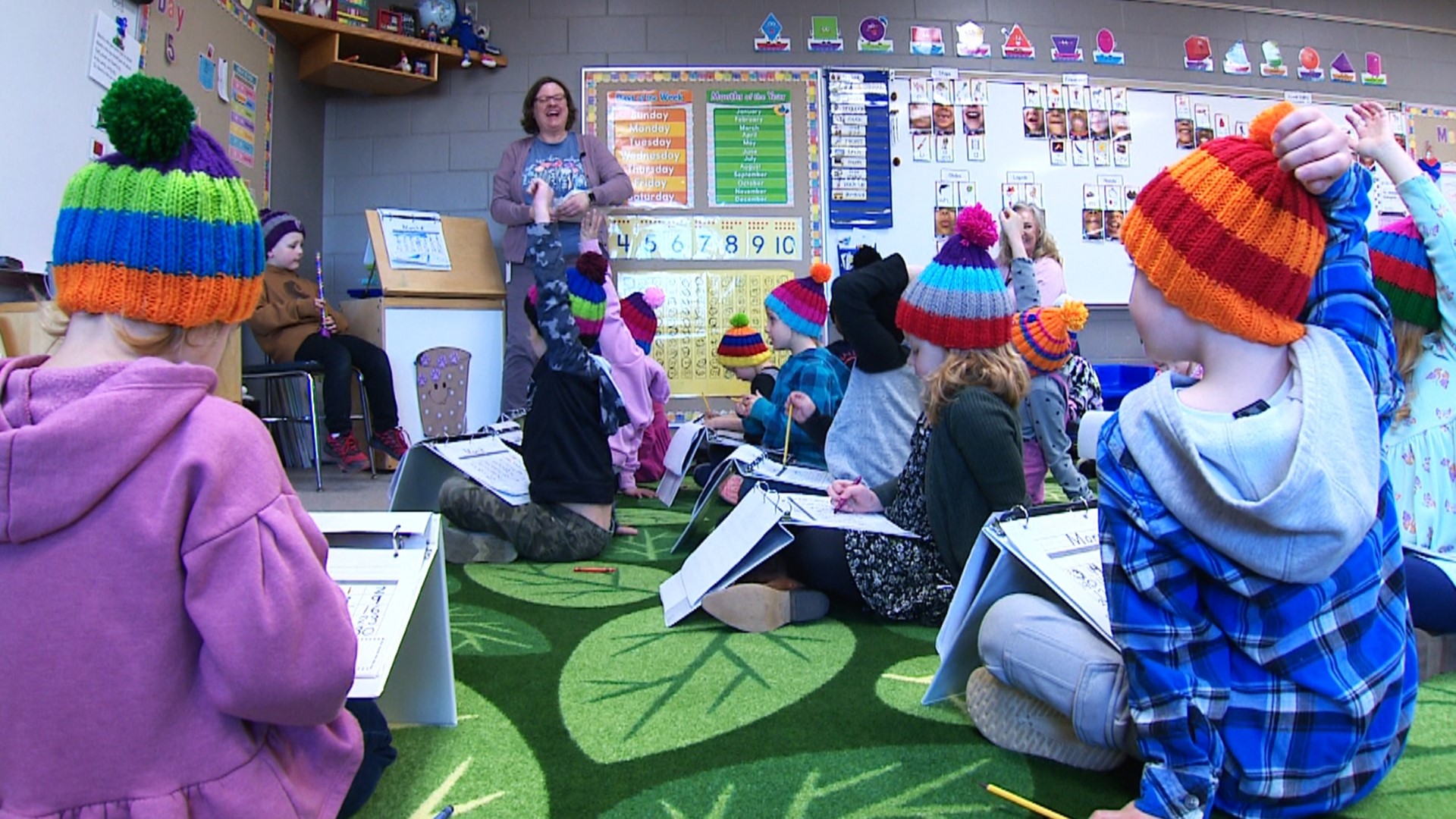 Teacher knits hats for students based on their designs | wqad.com