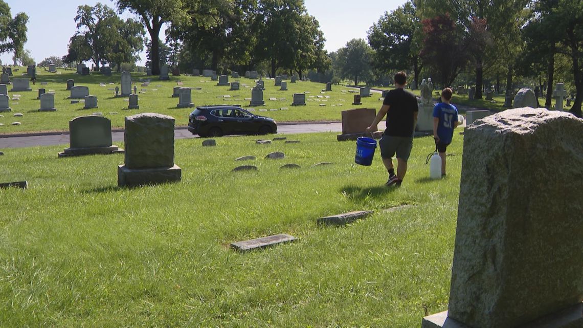 Father, son clean headstones at Cavalry Cemetery | wqad.com