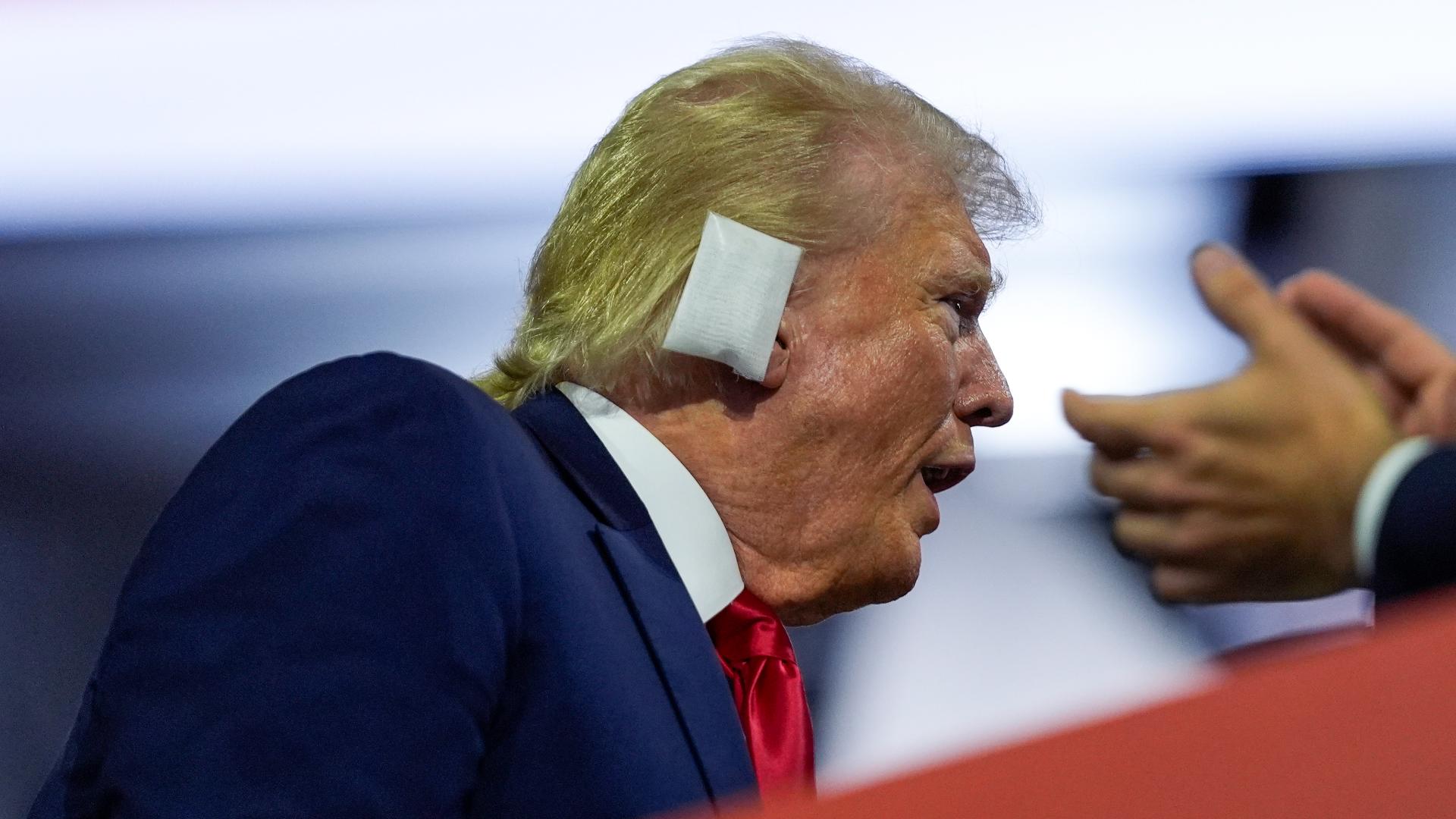 Trump receives hero's welcome with bandage on ear | wqad.com