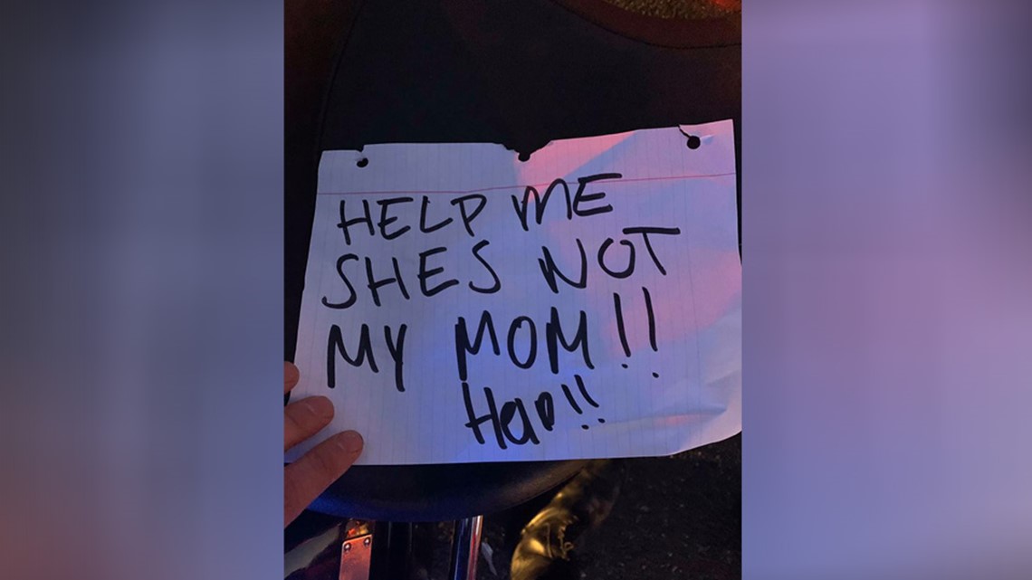 'Help me, she's not my mom': Backseat sign prompts police response ...