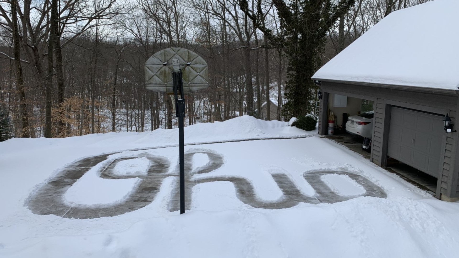 Man shovels Script Ohio, Block O in snow following Monday's storm ...