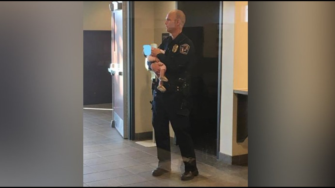 Photo Shows Officer Cradling Baby as Police Help Mom File Domestic ...