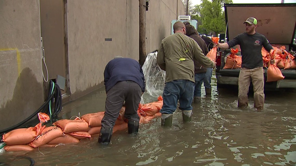 Business saved from flooding volunteers to help others in need | wqad.com