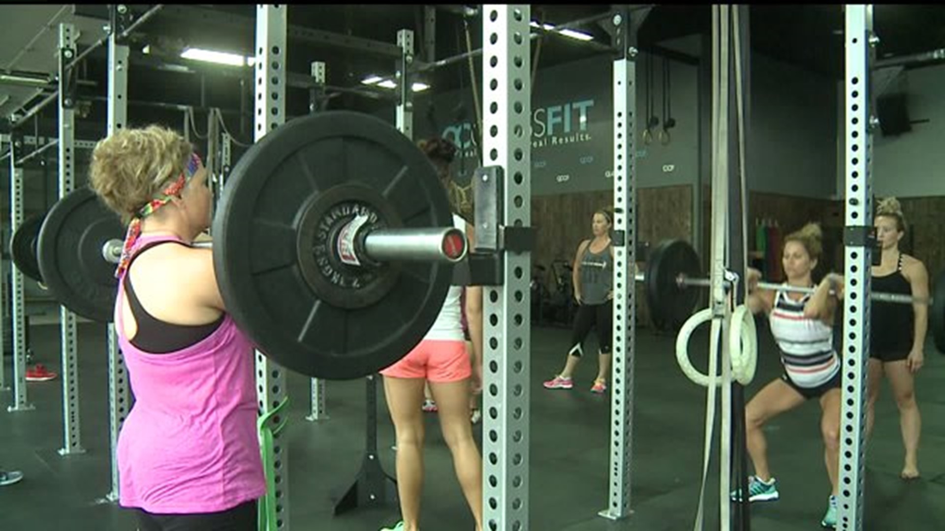 Crossfit trainers work to help each person reach their own most ...