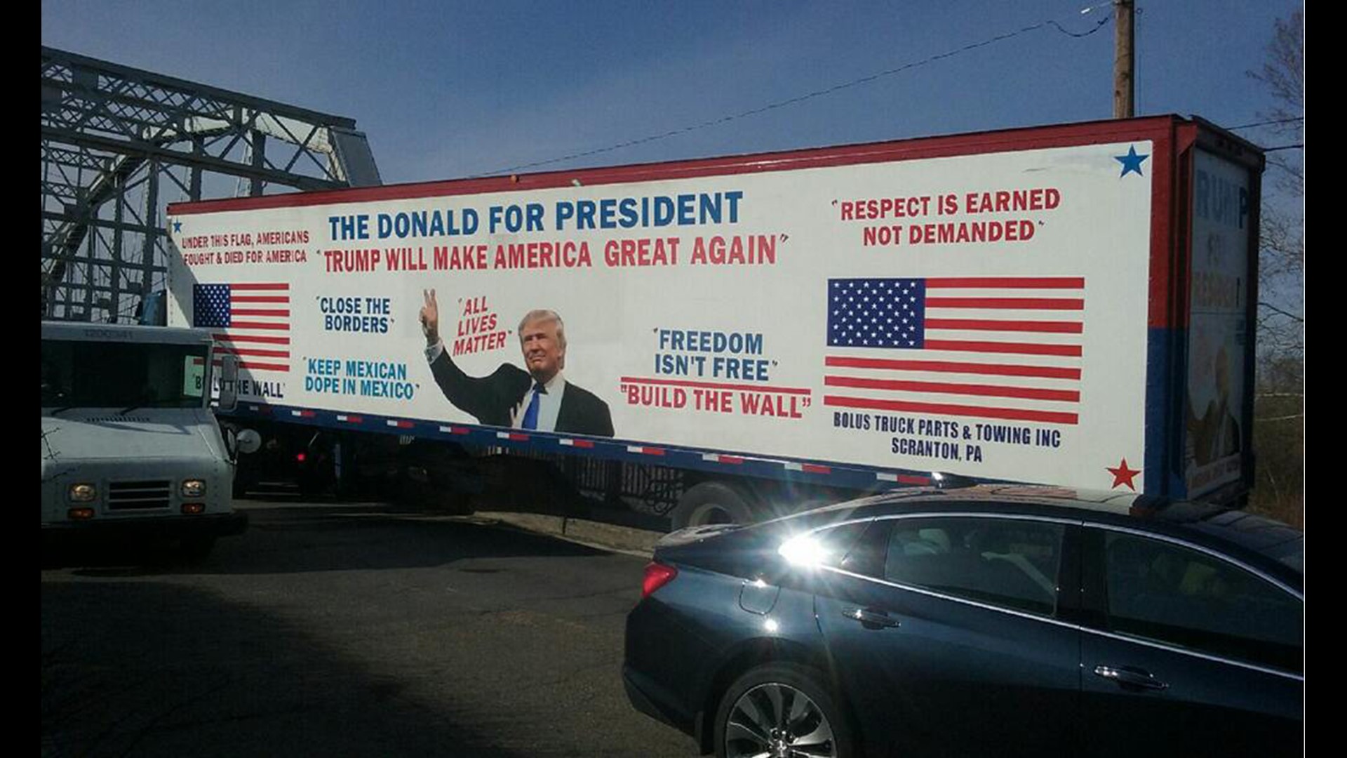 Tractor trailer advertising Trump gets stuck on bridge | wqad.com