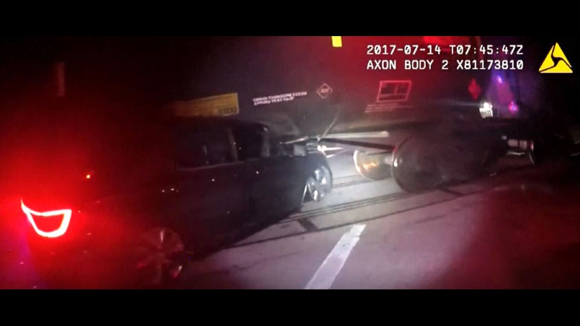 WATCH: Bodycam video shows officers respond to SUV caught under train ...