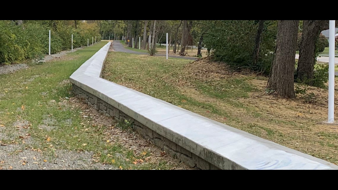 Controversial flood wall finished but residents not done paying for ...
