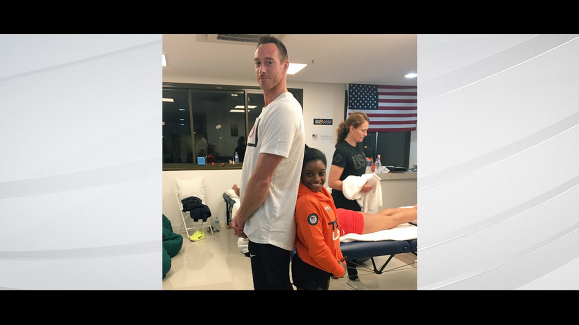 PHOTO: Simone Biles stands back to back with volleyball player David ...