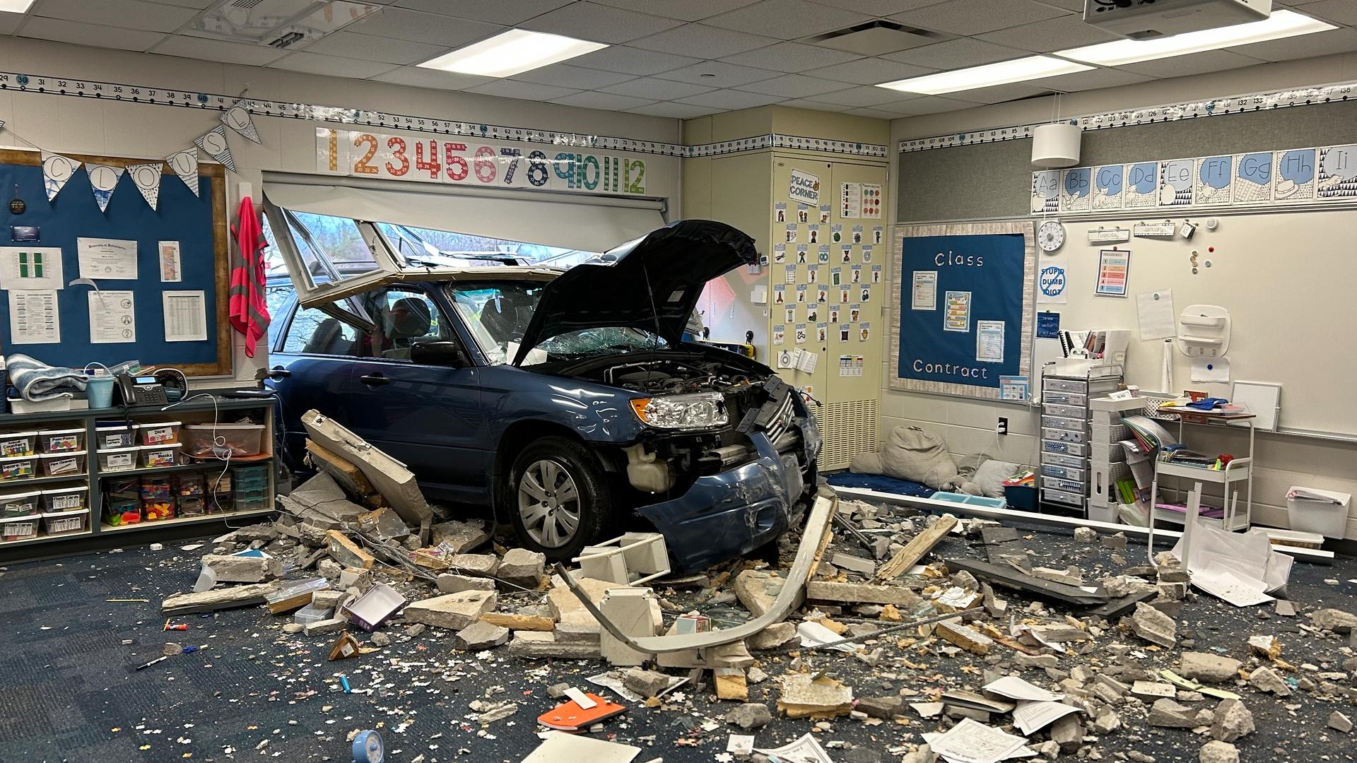 Child taken to hospital after car crashes into school on Indy's ...