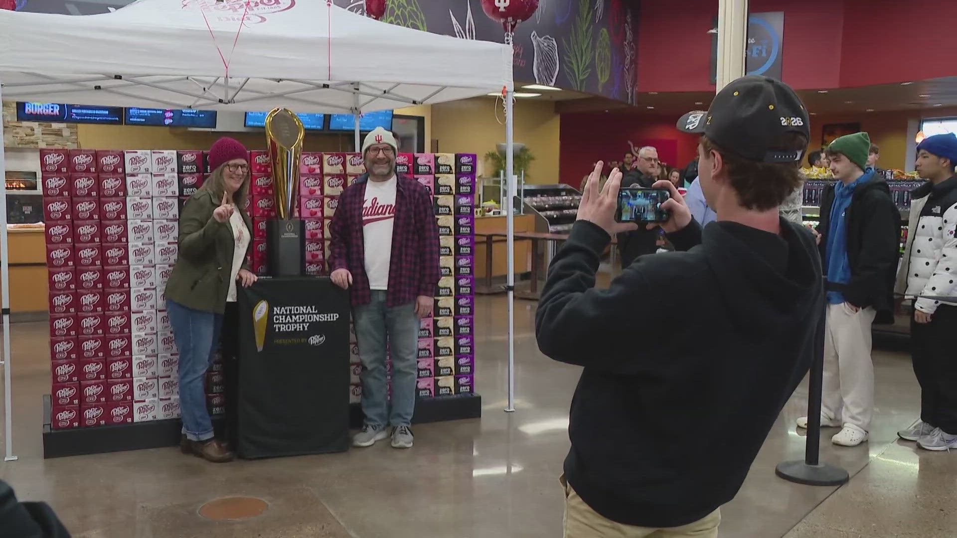 IU fans pose for photos with championship trophy in Bloomington | wthr.com