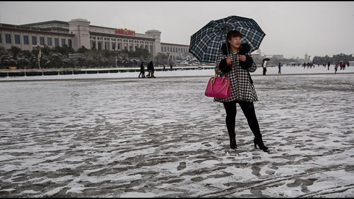 Beijing advises umbrellas to shield against its gross snow | fox61.com