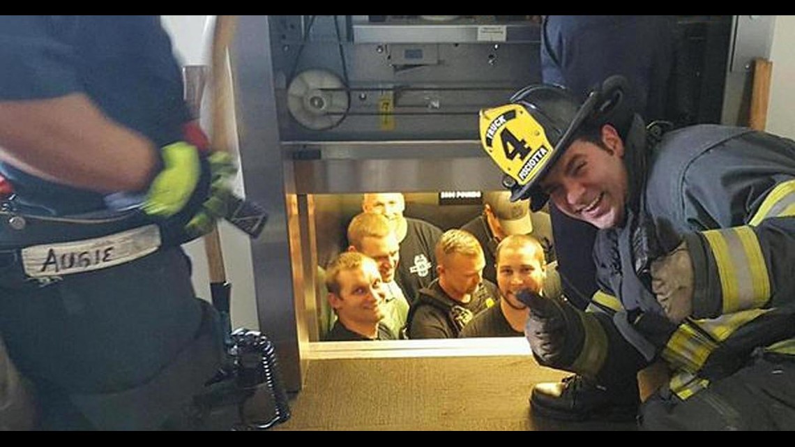 Firefighters snap photos as they rescue officers from stuck elevator at ...